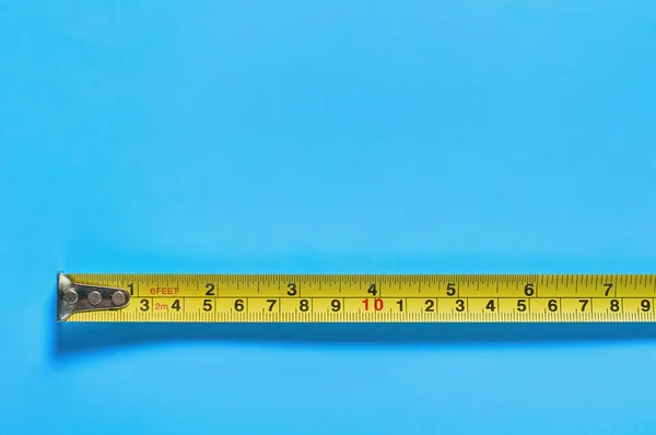 Ruler for measuring on blue desk in workshop. Space for text. Top view ...