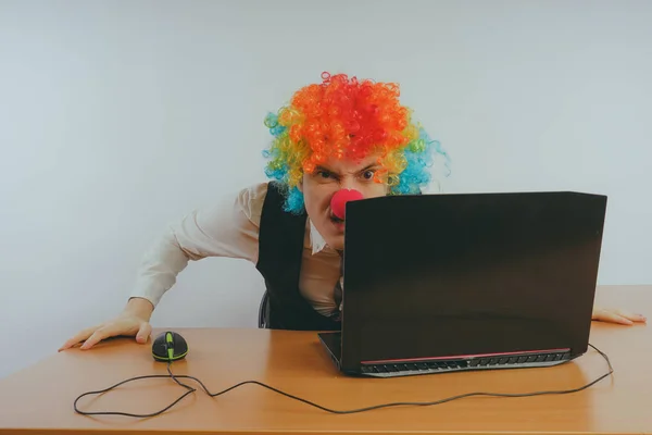 Office worker in clown wig, clown concept at work. Businessman at the ...