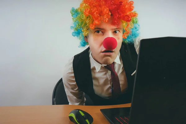 Office worker in clown wig, clown concept at work. Businessman at the ...