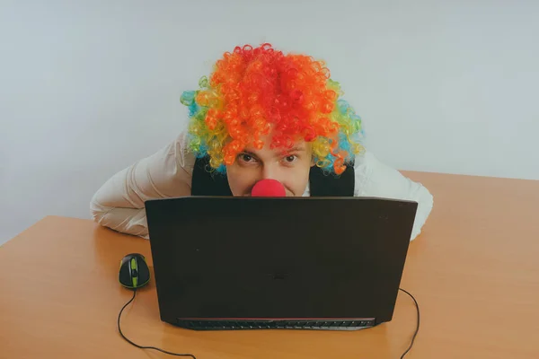 Office worker in clown wig, clown concept at work. Businessman at the ...