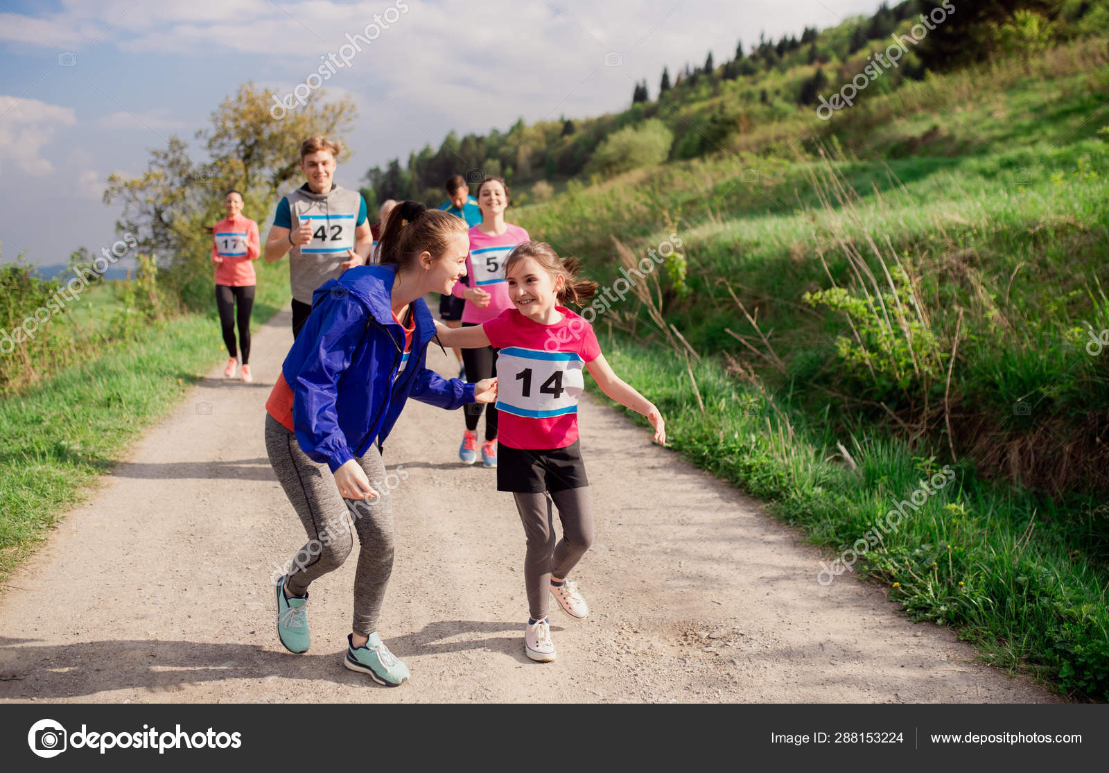 Large group of multi generation people running a race competition in ...