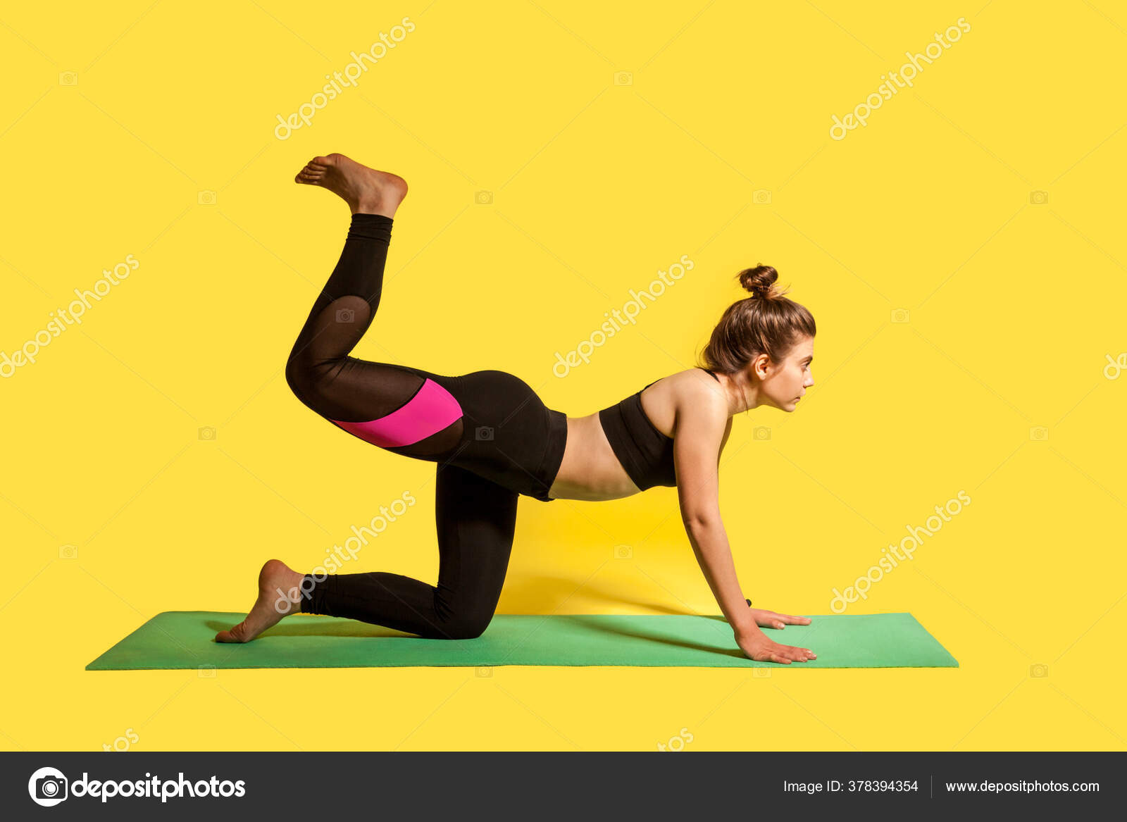Slim Fitness Woman Hair Bun Tight Sportswear Practicing Yoga Doing