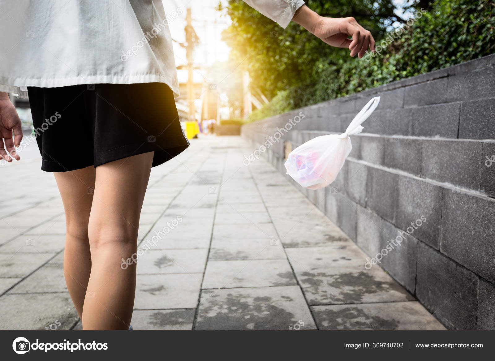 Woman hand throwing trash on the floor in public areas,female people ...