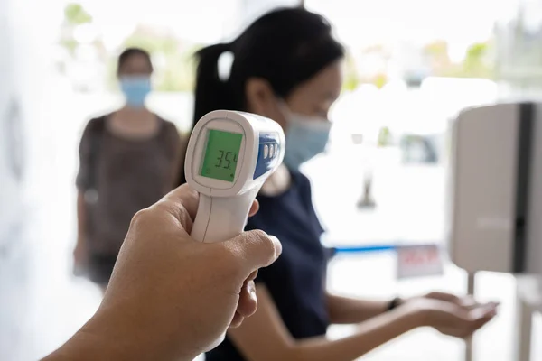 Check body temperature screening using thermometer,prevent people with ...