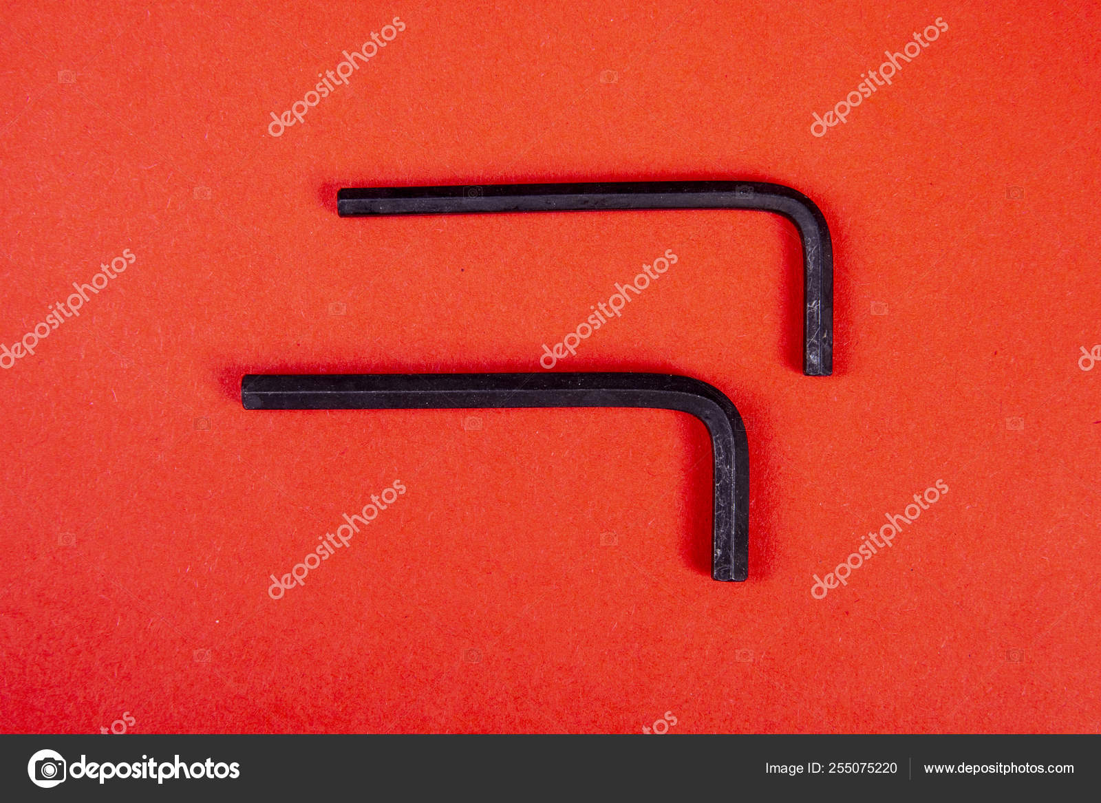Two Allen keys on red background Stock Photo by ©Haylight 255075220