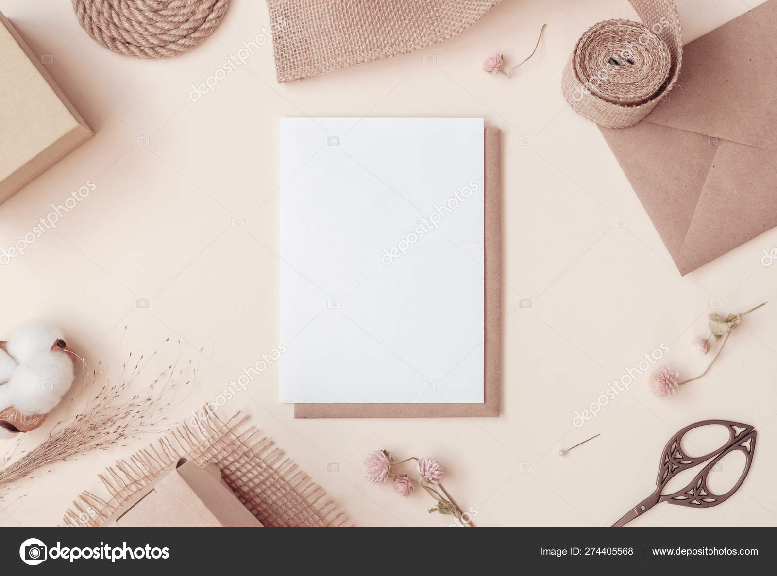 Workspace. Invitation cards, craft envelopes, cotton flower on light ...