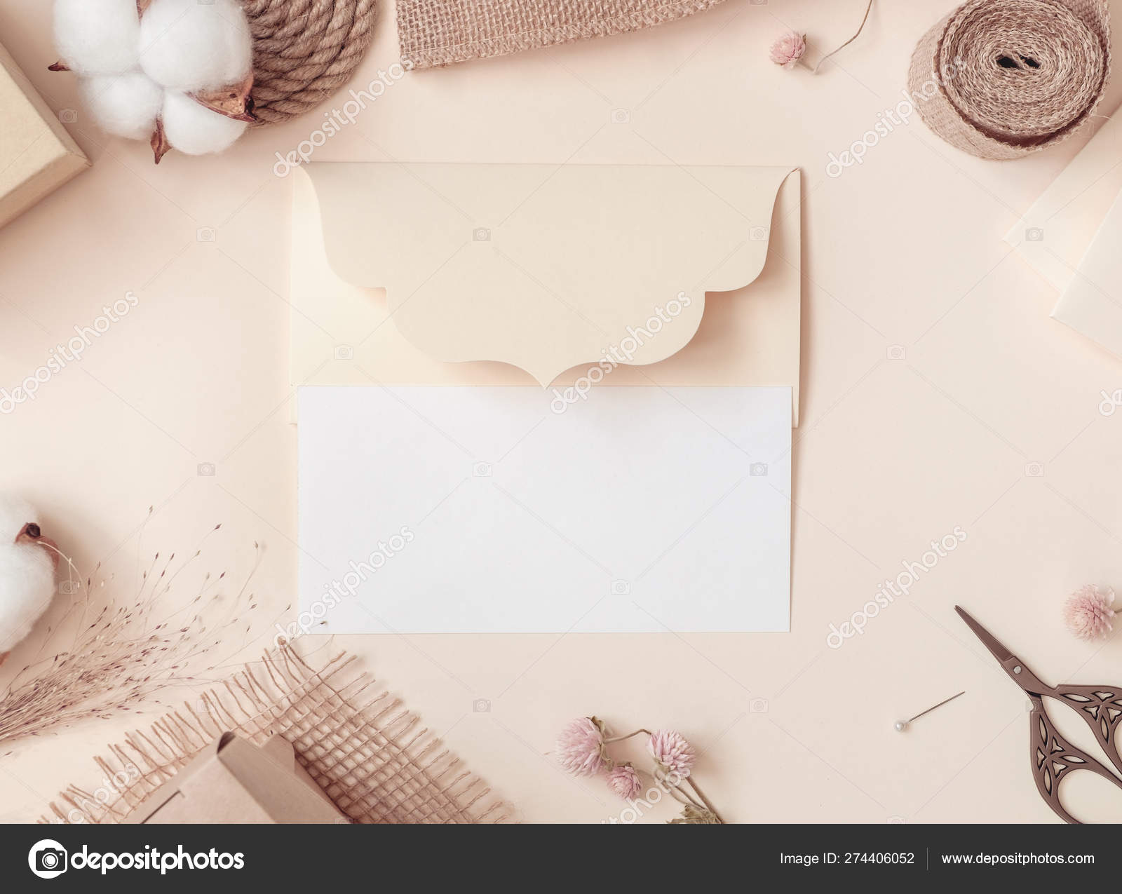Workspace. Invitation cards, craft envelopes, cotton flower on light ...