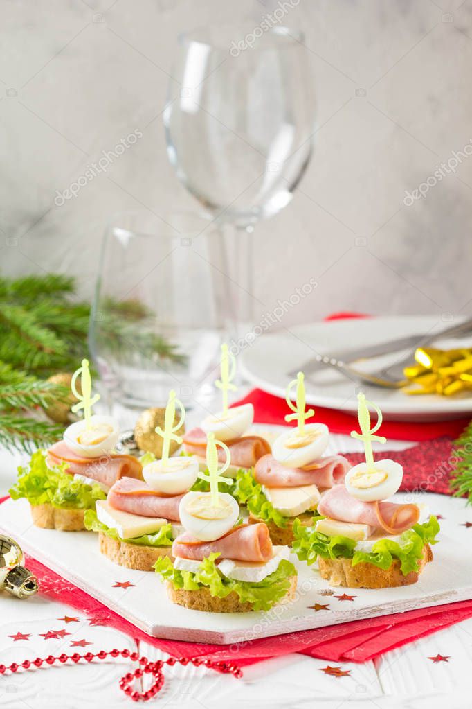 Canapés de Navidad sobre pan con queso brie o Camembert, jamón y huevo ...