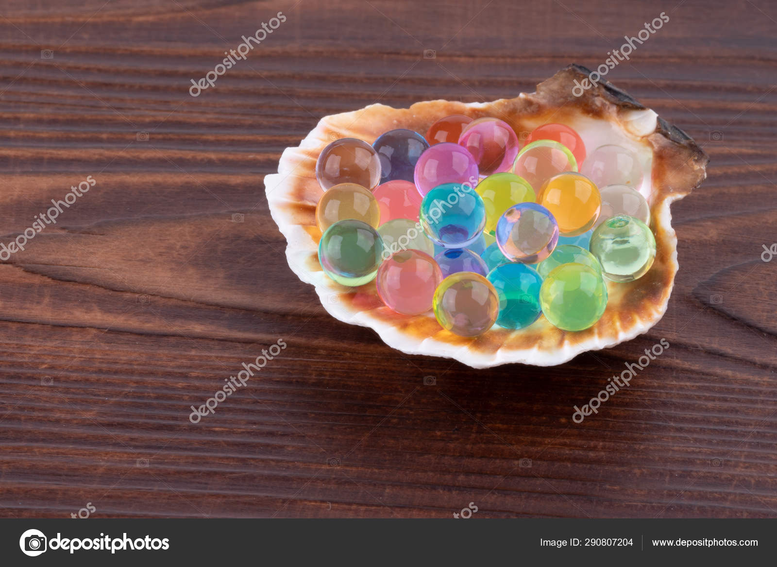 Sea shell with multicolored hydrogel balls macro — Stock Photo ...