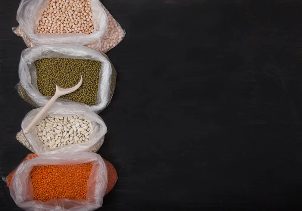White beans, red lentils, peas and mung bean in plastic bags on - Stock ...