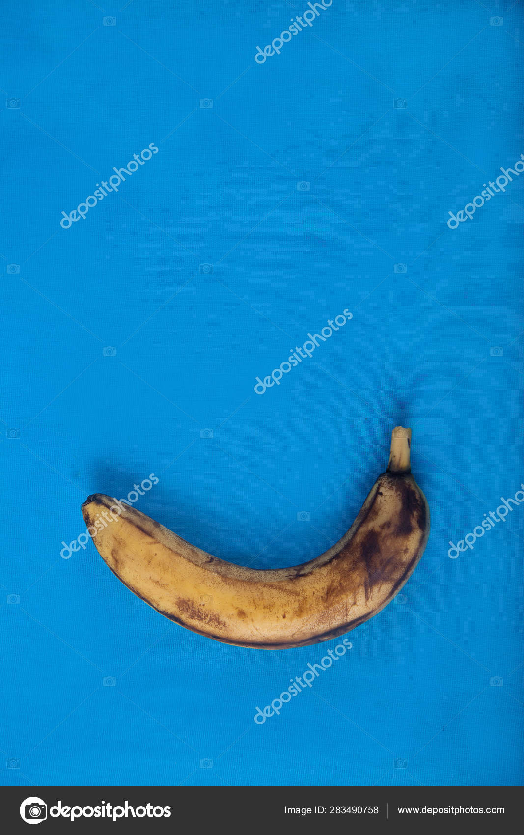 Ugly overripe banana on a blue background. Close-up. Stock Photo by ...