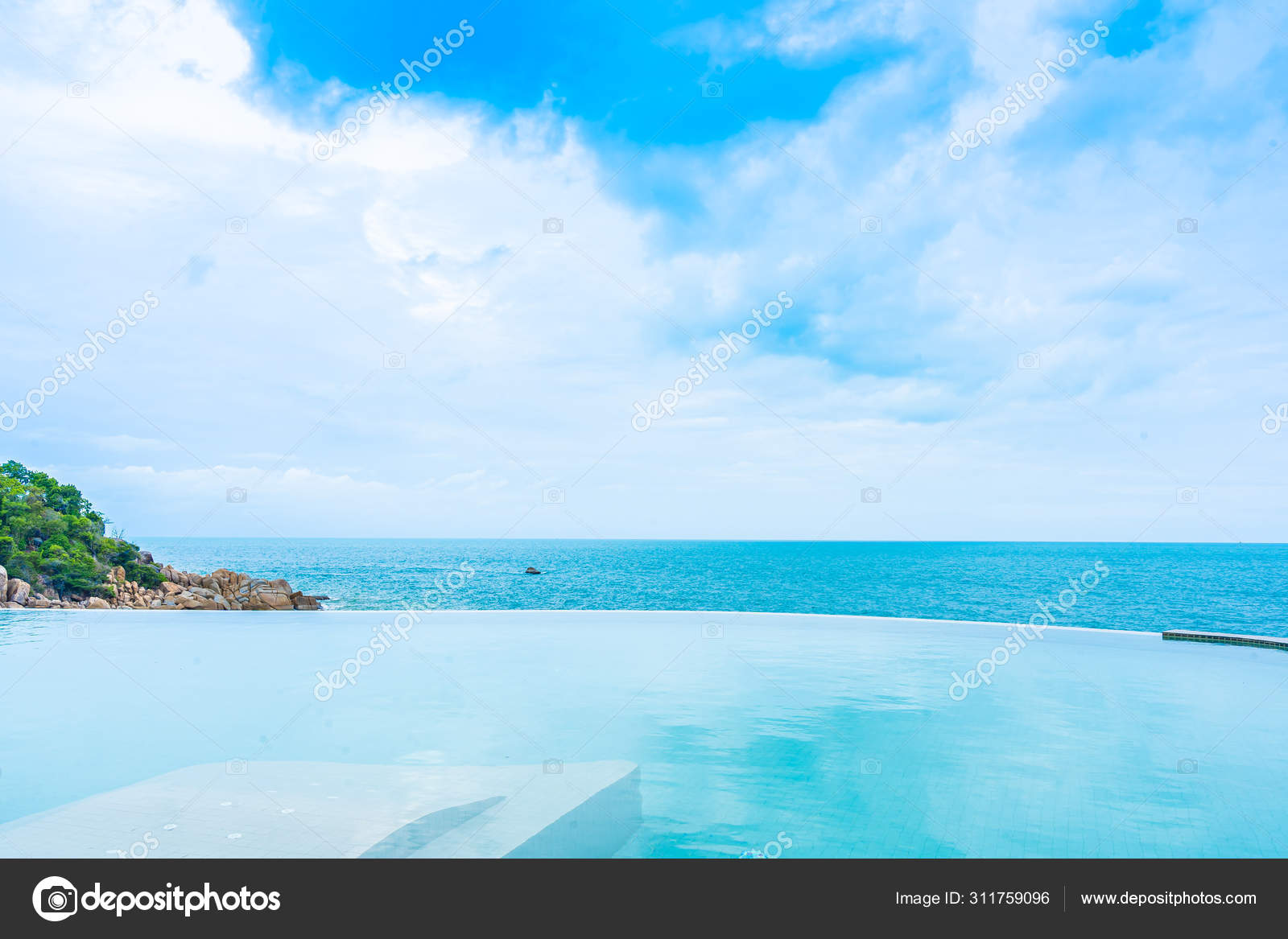 Beautiful outdoor infinity swimming pool in hotel resort with se ...