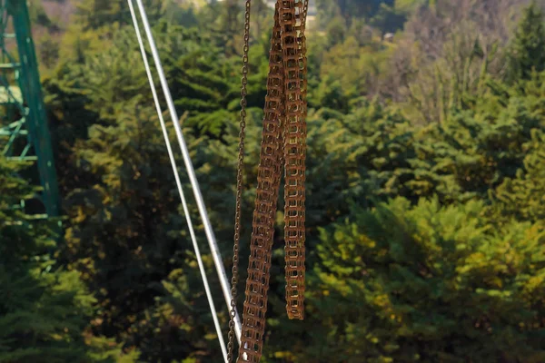 Winch with chain suspended. Old rusty chain mechanism. Winch with chain ...
