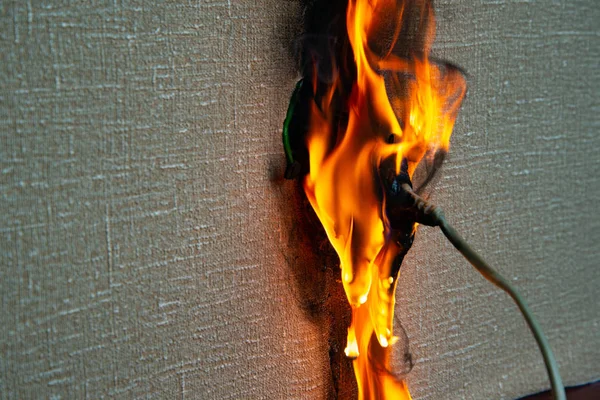Burning electrical wiring and electrical outlet. Faulty wiring causes ...