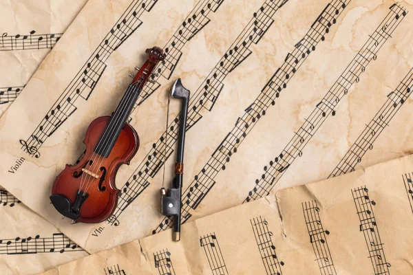 Violin on vintage music notes paper background with copy space - Stock ...