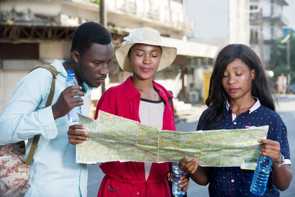 Group Young Tourists Standing Staring Map While Smiling — Stock Photo ...