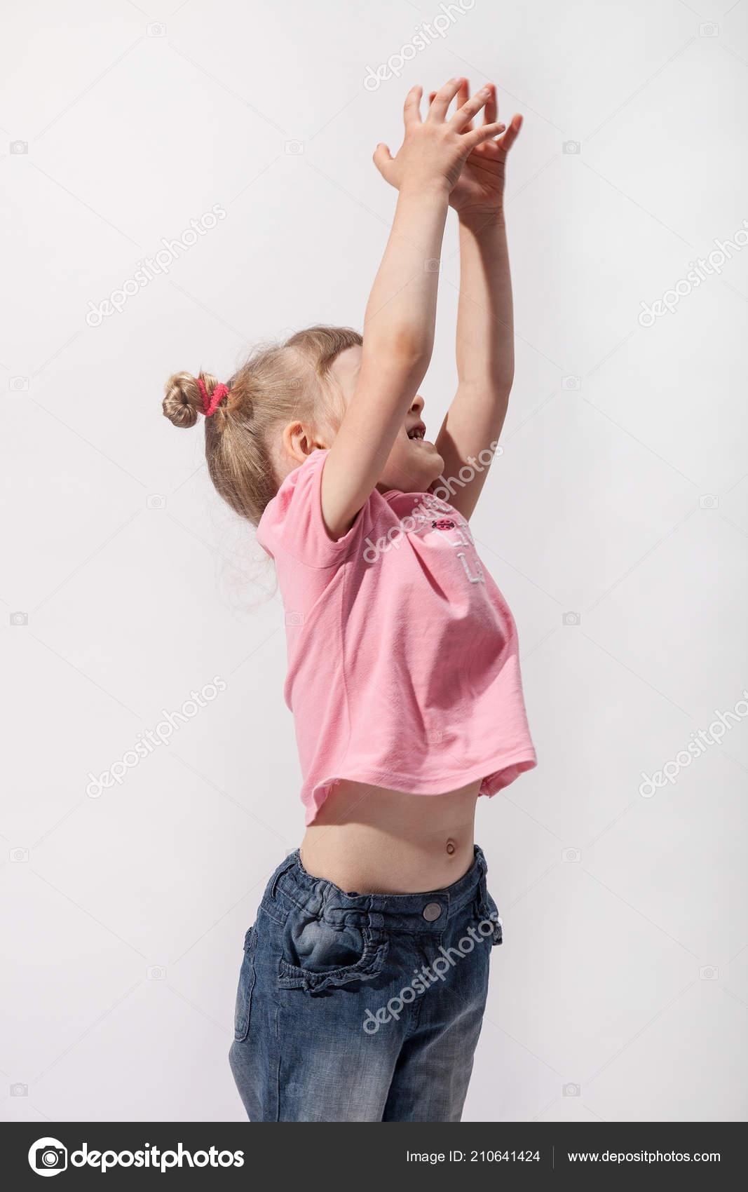 Active Little Girl Catching Something Her Hands Neutral Background ...