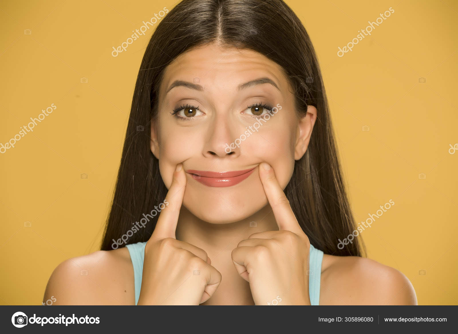 Young Woman Forcing Her Smile Her Fingers Yellow Background Stock Photo ...