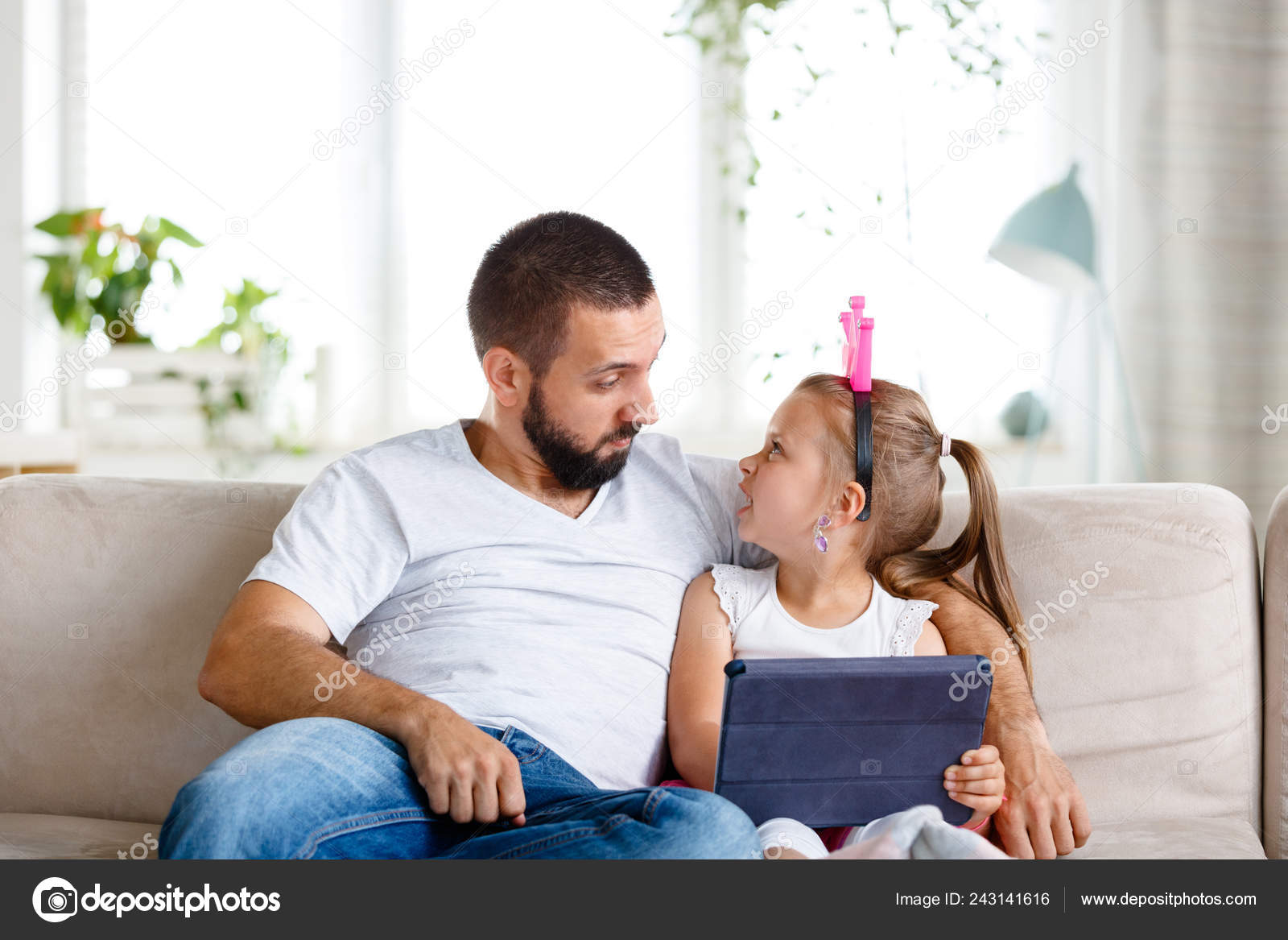 Father Daughter Sitting Sofa Home Using Digital Tablet Together Making