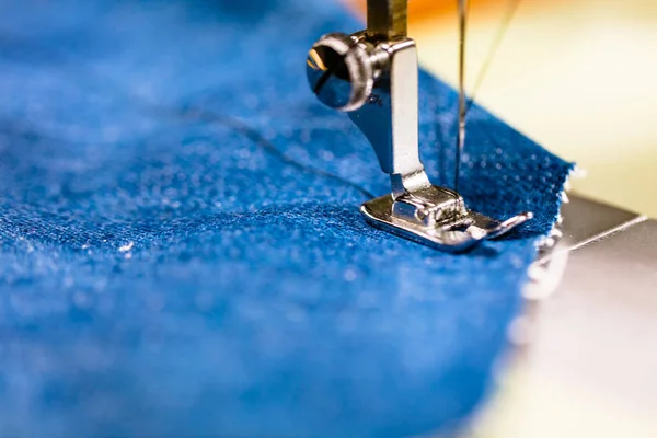 Sewing denim jeans with sewing machine. Repair jeans by sewing machine ...