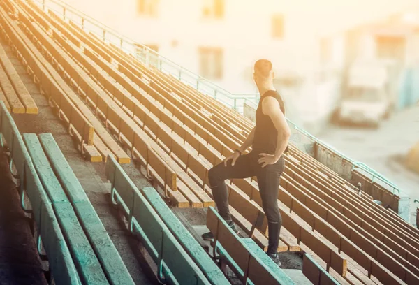 Caucasian man trains in running on the stairs. Track and field runner ...
