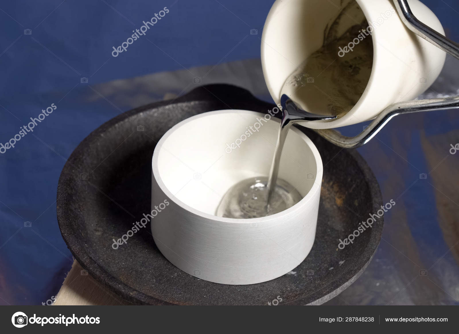 Pouring molten lead in ceramic ware. Heat-resistant ceramics. — Stock ...