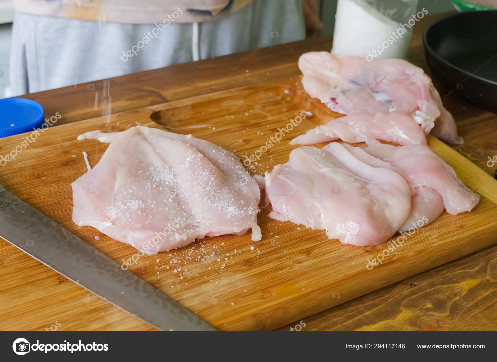 Cutting poultry meat. Broiler breast, chicken meat on cutting bo ...