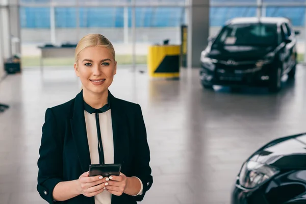 online customer support. sales agent using tablet in car showroom ...