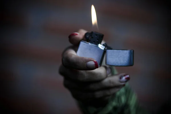 Holding lighter lit on black background Stock Photo by ©Giovanni.seabra ...
