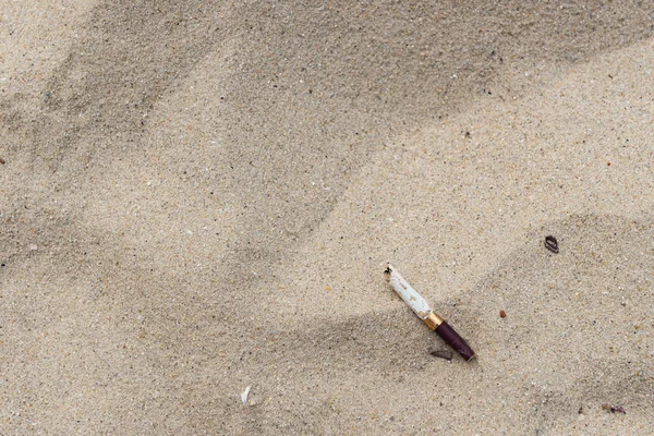 Cigarette stub on sand Stock Photos, Royalty Free Cigarette stub on ...