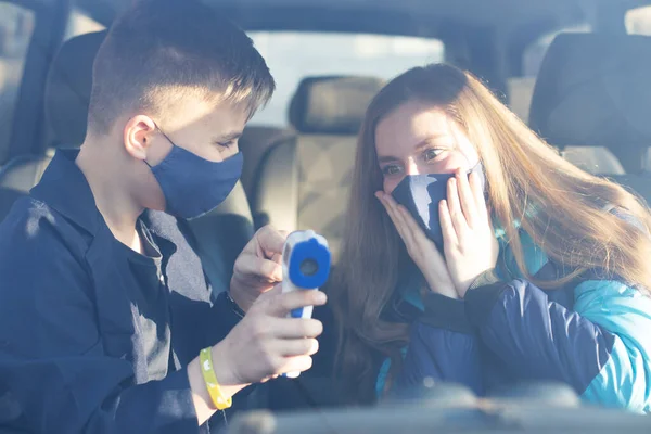 People gets body temperature measured with an infrared non-contact ...