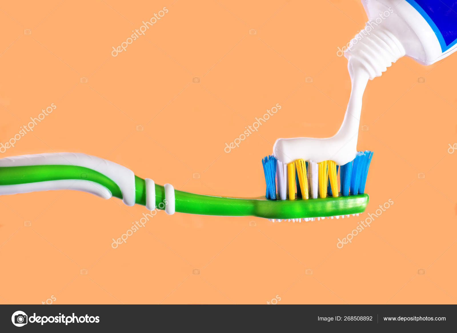 Toothbrush squeezed on toothbrush toothpaste Orange background Stock ...