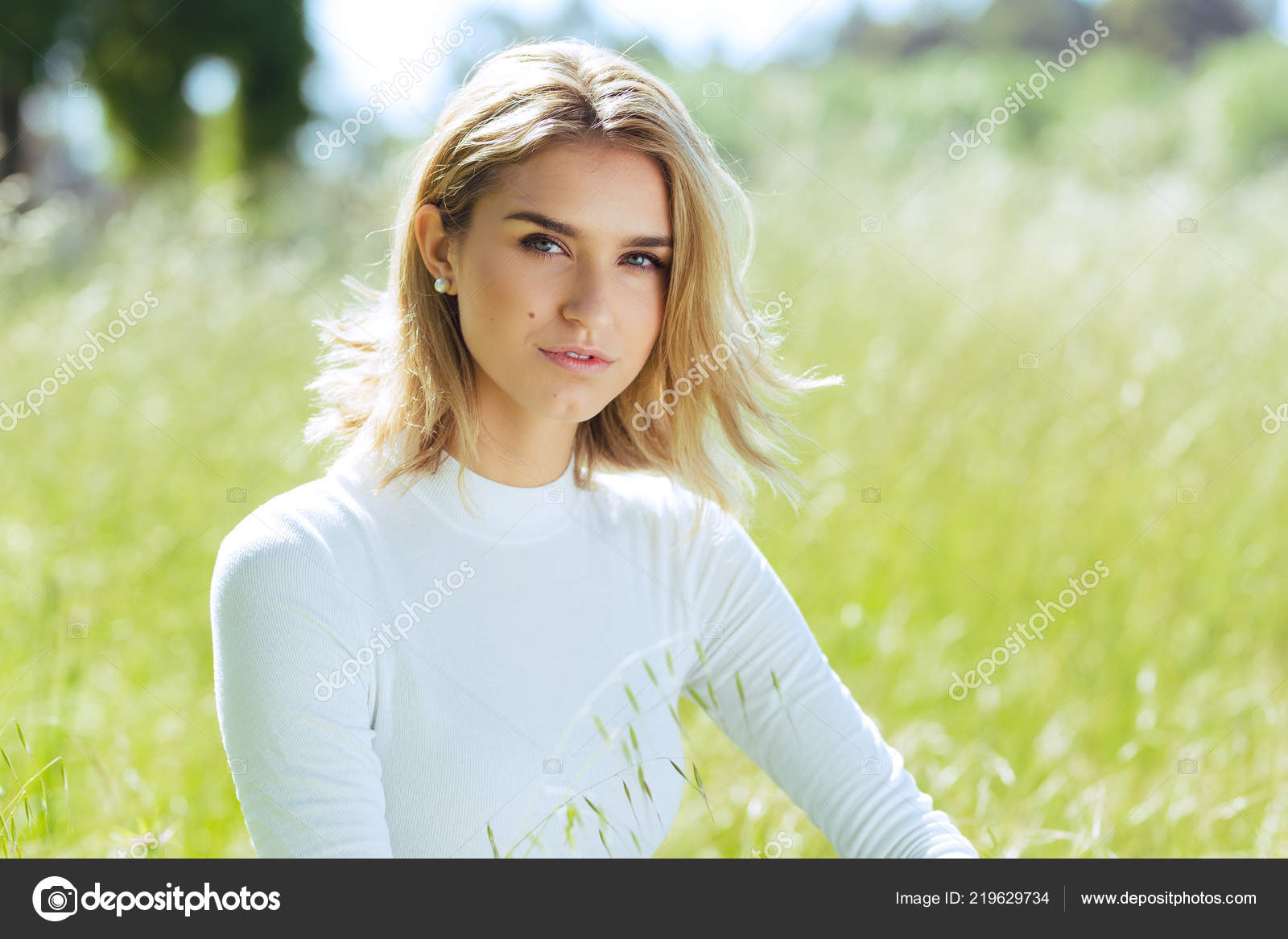 Attractive Young Blonde Caucasian Woman Tight White Top Denim Posing