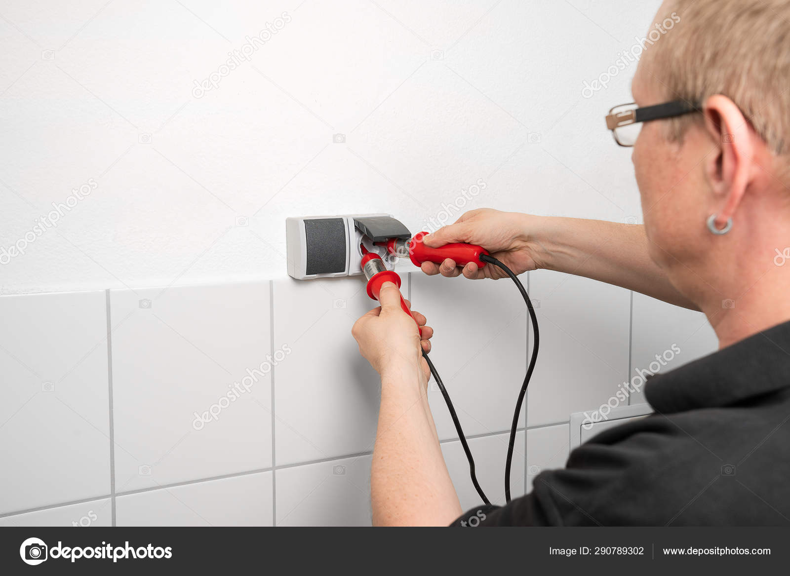 Electrician checks a socket with a voltage indicator — Stock Photo ...