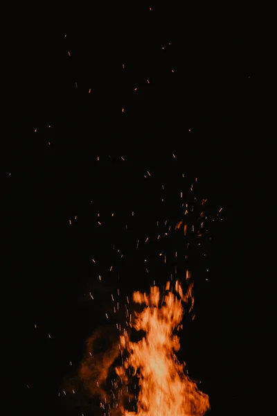 Fire flames and bonfire sparks in the dark sky at night - Stock Image ...