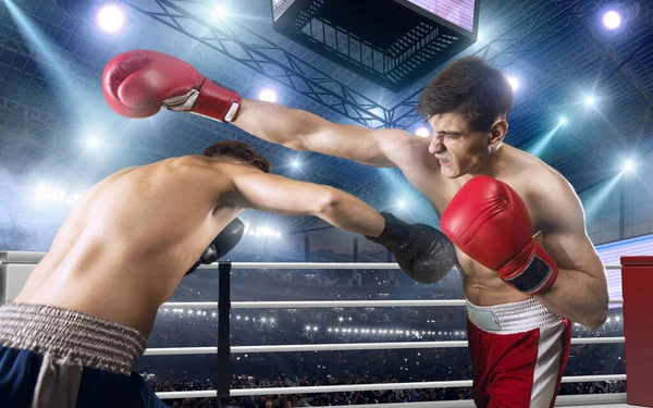 Two boxers are fighting on professional boxing ring. - Stock Image ...
