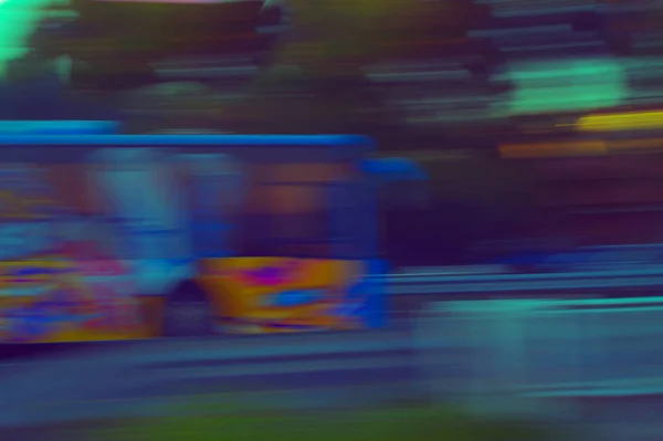 Colorful bus moving fast along the road on a multi colored blurred ...