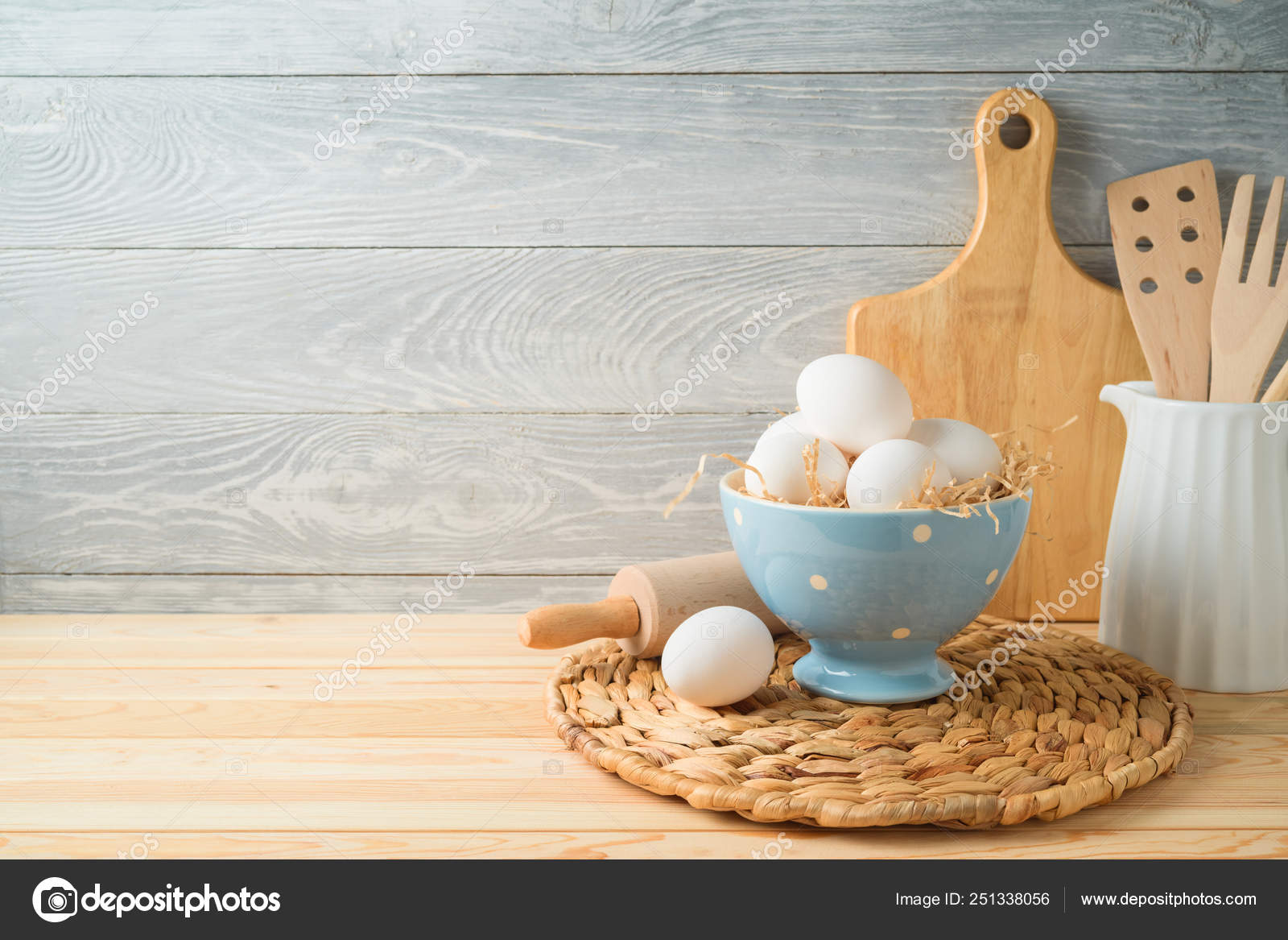 Easter baking background with eggs and kitchen utensils on woode ...