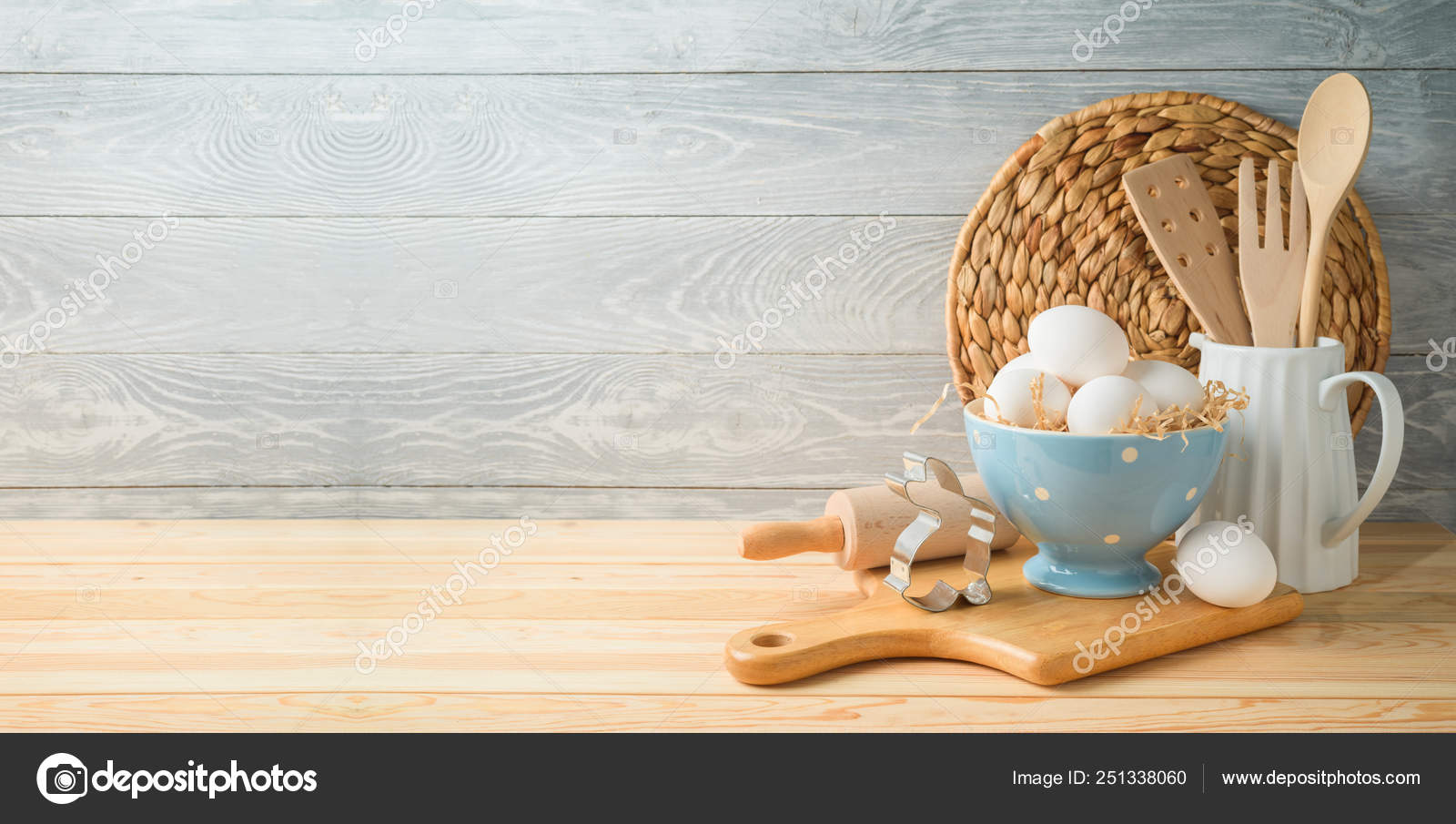 Easter baking background with eggs and kitchen utensils on woode ...