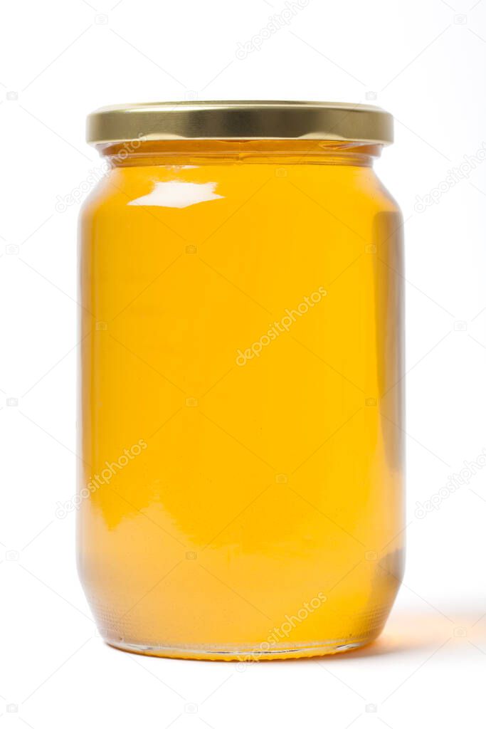 Miel de hierbas fresca y clara en un frasco transparente limpio cerrado ...