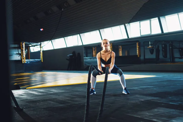 Full length wide angle shot of a young woman working out with ba ...