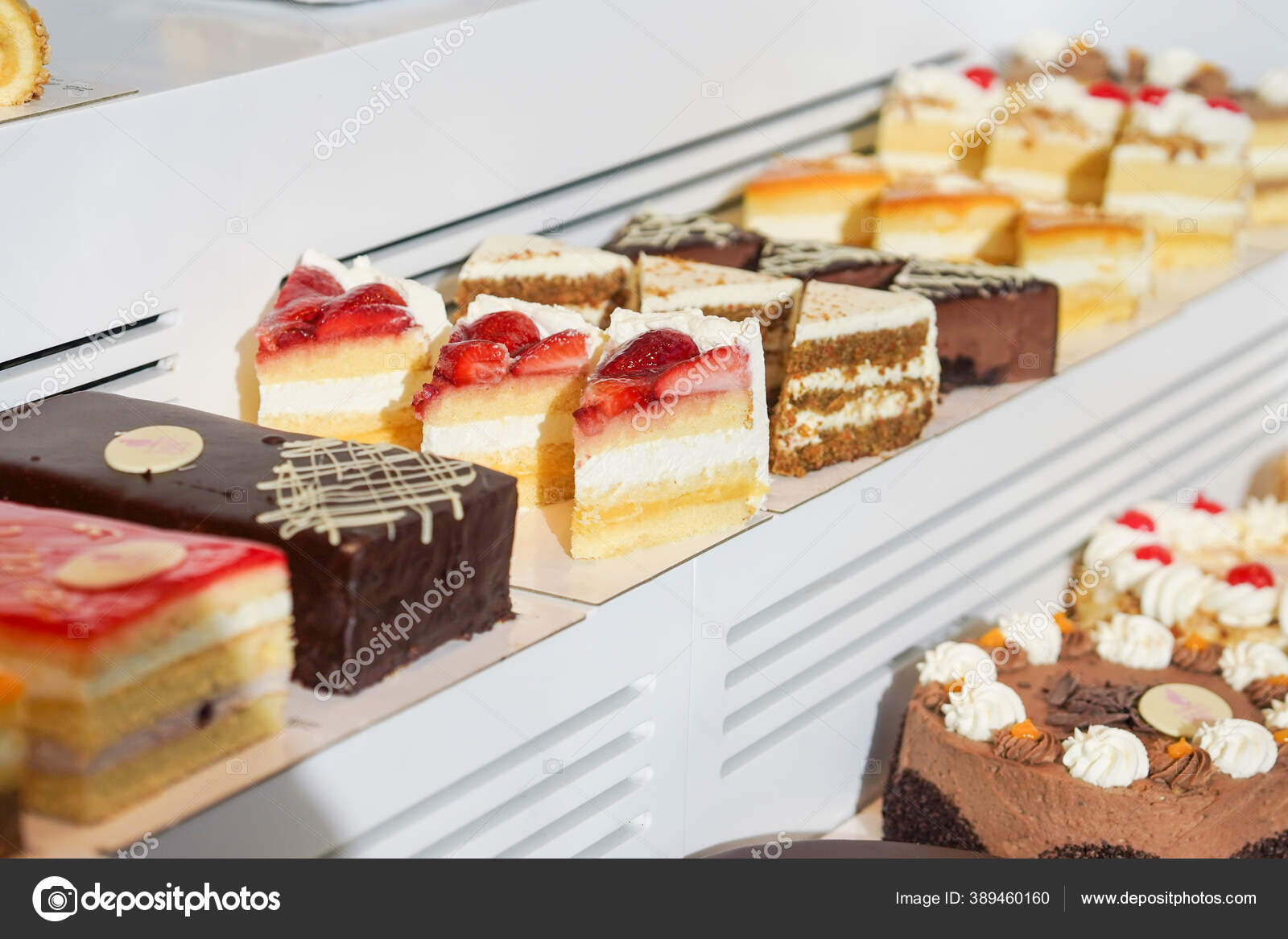 Cakes in the window of a bakery. — Stock Photo © javiindy #389460160
