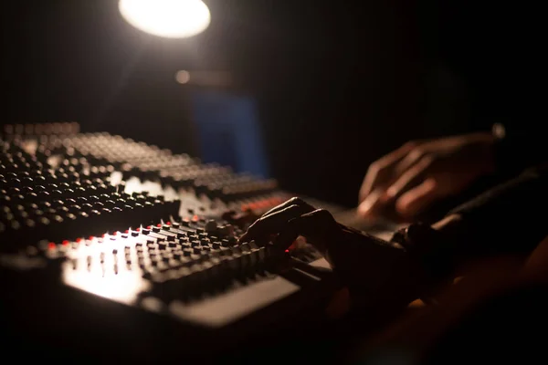 Sound technician and lights technicians control the music show in night ...