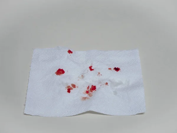 Blood on tissue paper on white background. Health medical concept ...