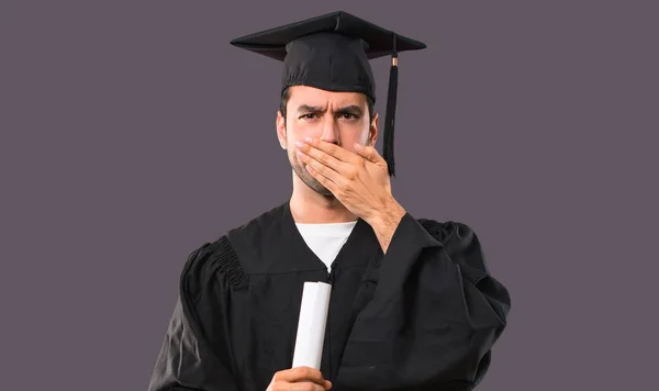 Man on his graduation day University covering mouth with hands for ...