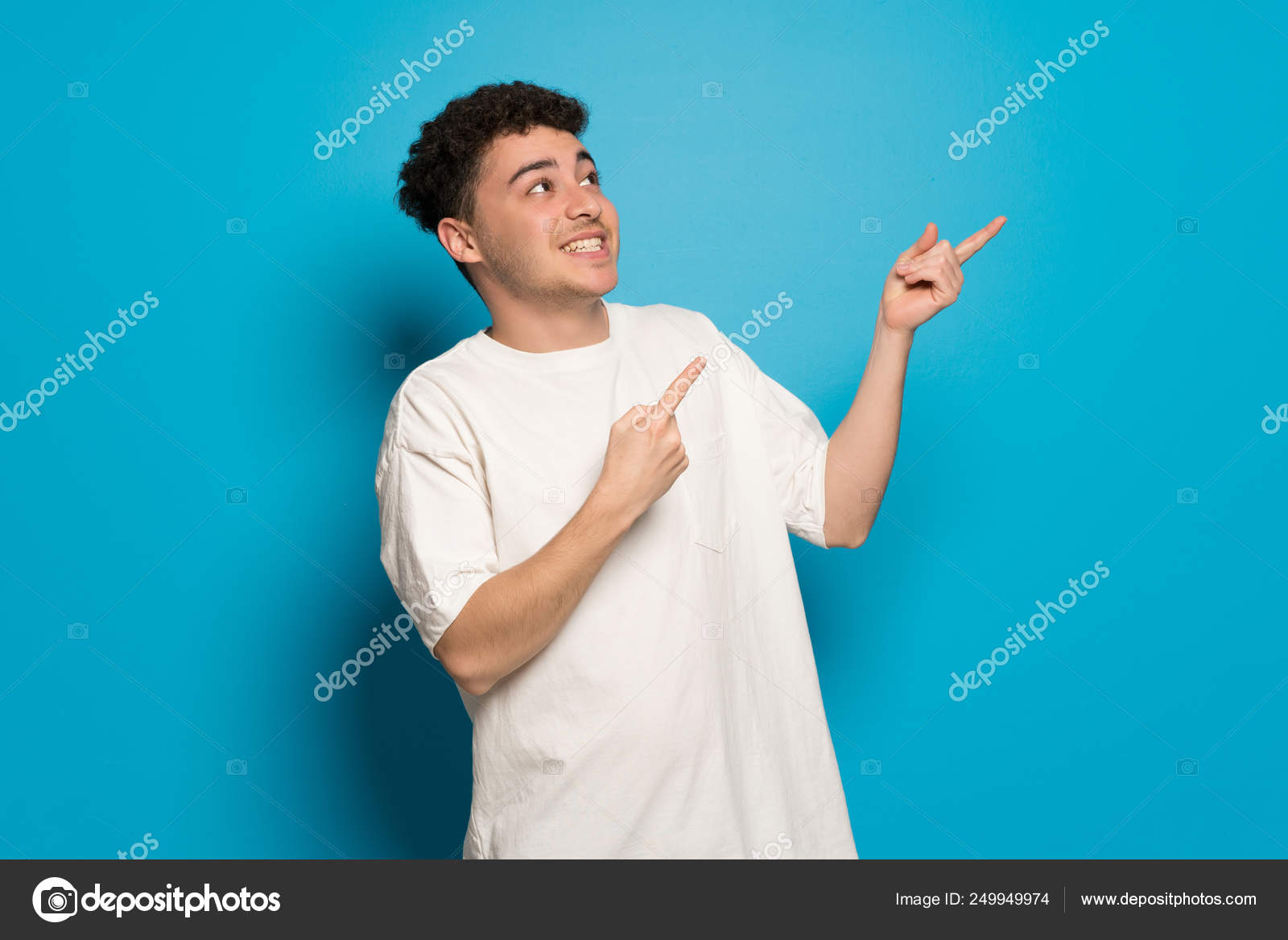 Young Man Blue Background Pointing Index Finger Looking Stock Photo by ...