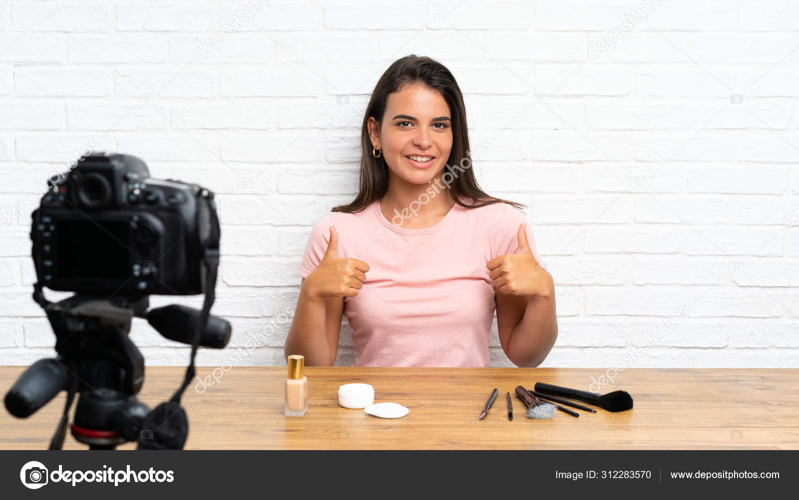 Young Girl Recording Video Tutorial Giving Thumbs Gesture Stock Photo by ©luismolinero 312283570