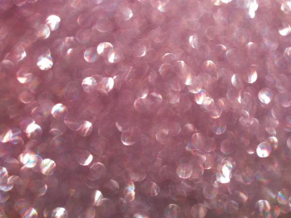 Rose pink blurred glitter background with round sparkling highlights ...