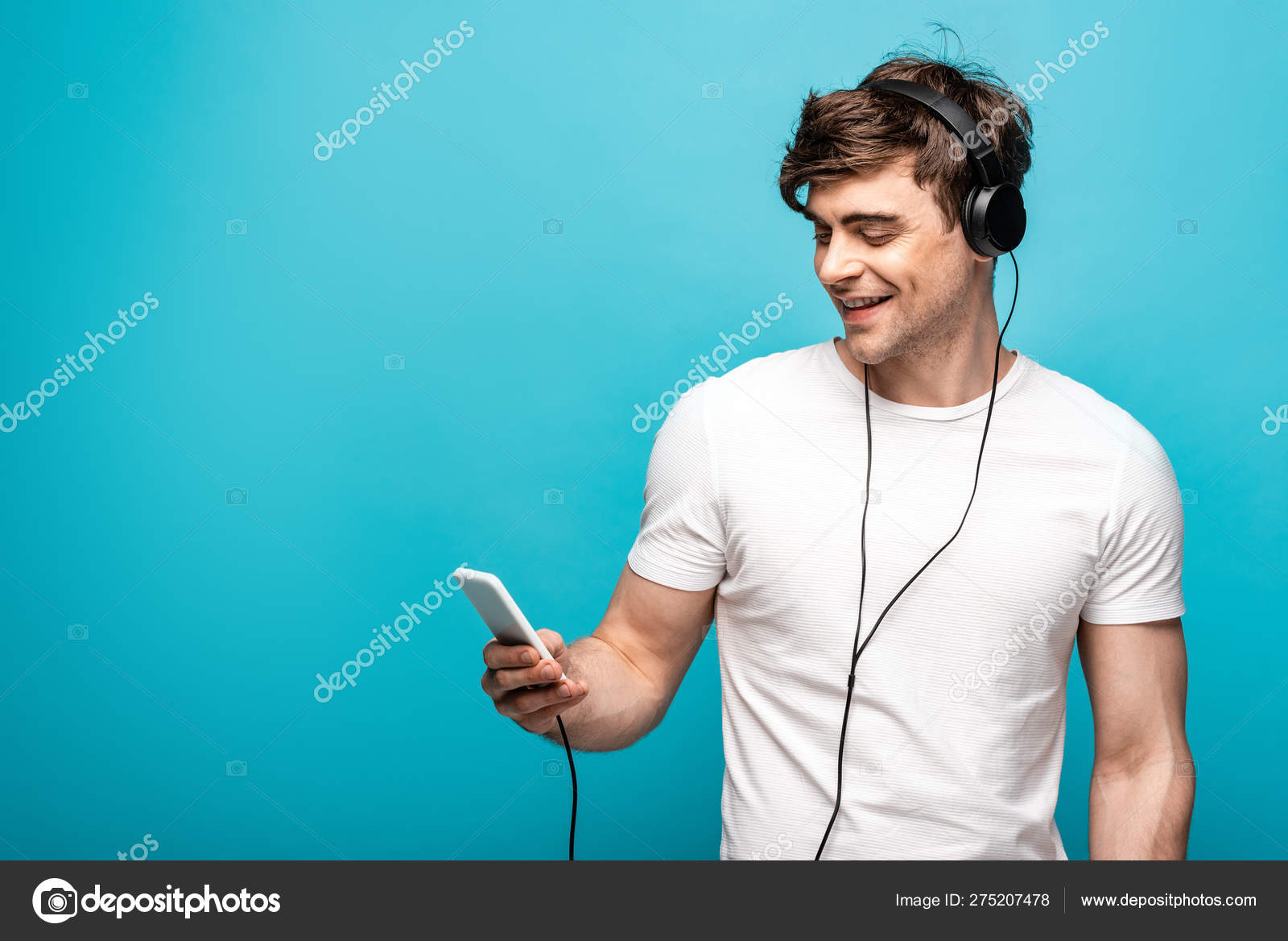 Handsome Young Man Smiling While Listening Music Headphones Smartphone ...