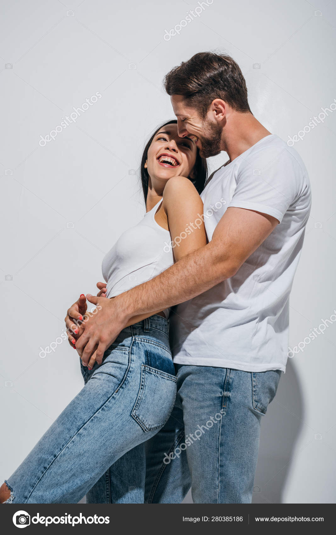 Young Man Standing Girlfriend Hugging Her While Looking Each Other